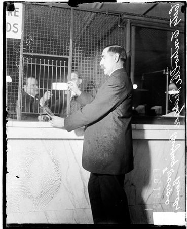 Chicago History Museum Images - John E. Traeger standing, slipping a ...